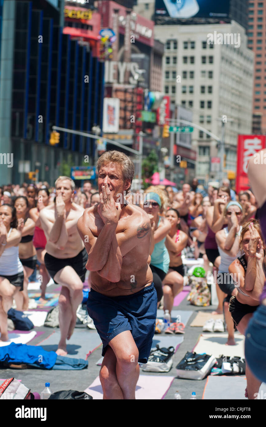 Thousands of yoga practitioners in Times Square in New York participate ...
