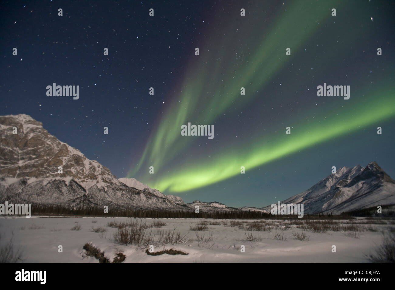 Aurora borealis fill the sky over high peaks of the Central Brooks ...