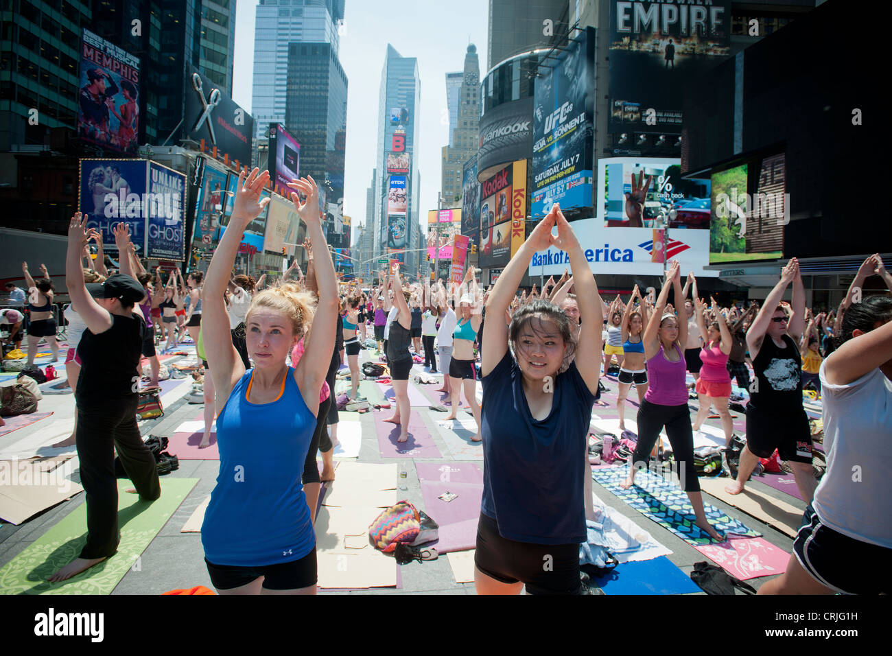 Thousands of yoga practitioners in Times Square in New York participate ...