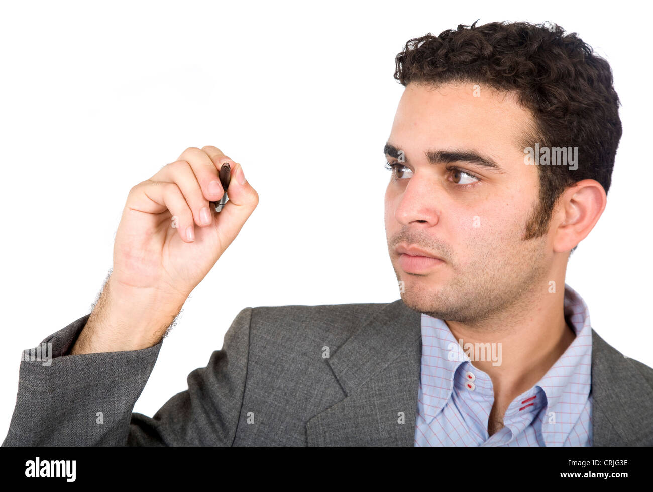 young man writing something on an imaginary glass pane in front of him ...