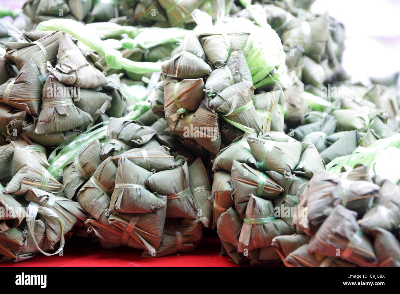 Bundle of small Chinese rice dumplings wrapped in reed leaves Stock ...