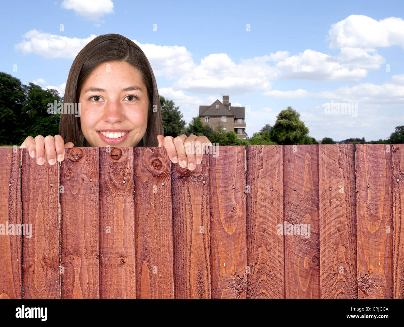 beautiful girl over a fence with a house in the background Stock Photo ...