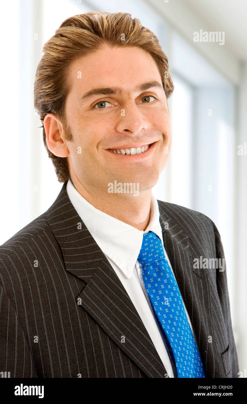 Friendly business man portrait - smiling in his office Stock Photo - Alamy