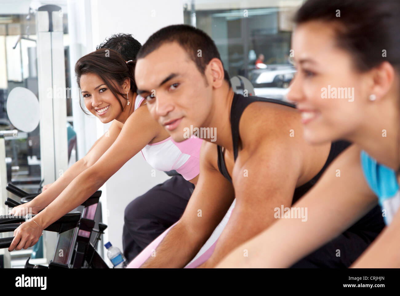 people at the gym working out on the cycling machines Stock Photo - Alamy
