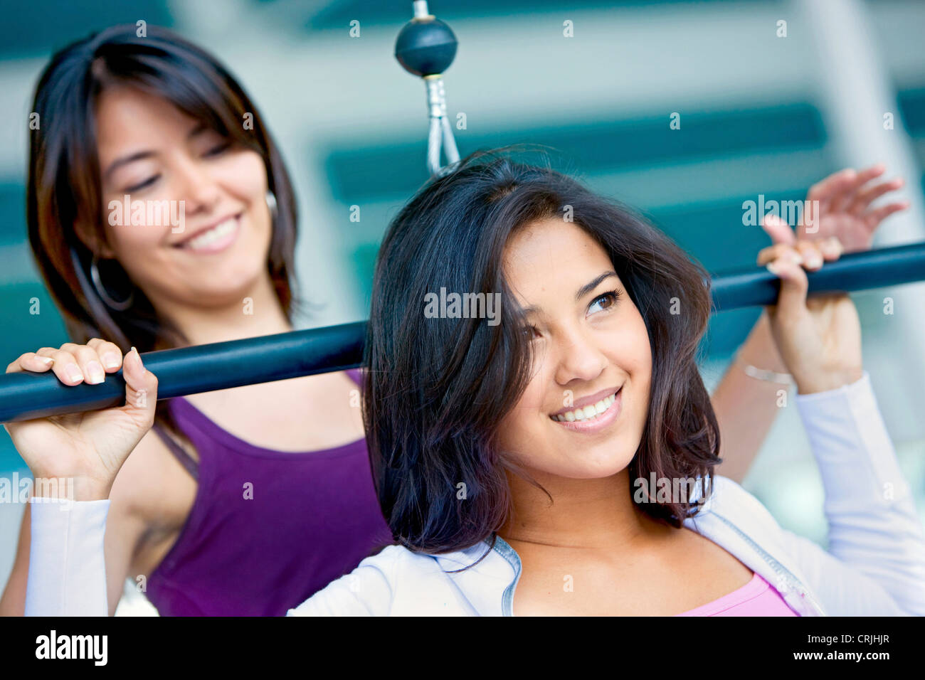 girls at the gym doing upper back machine exercises Stock Photo - Alamy