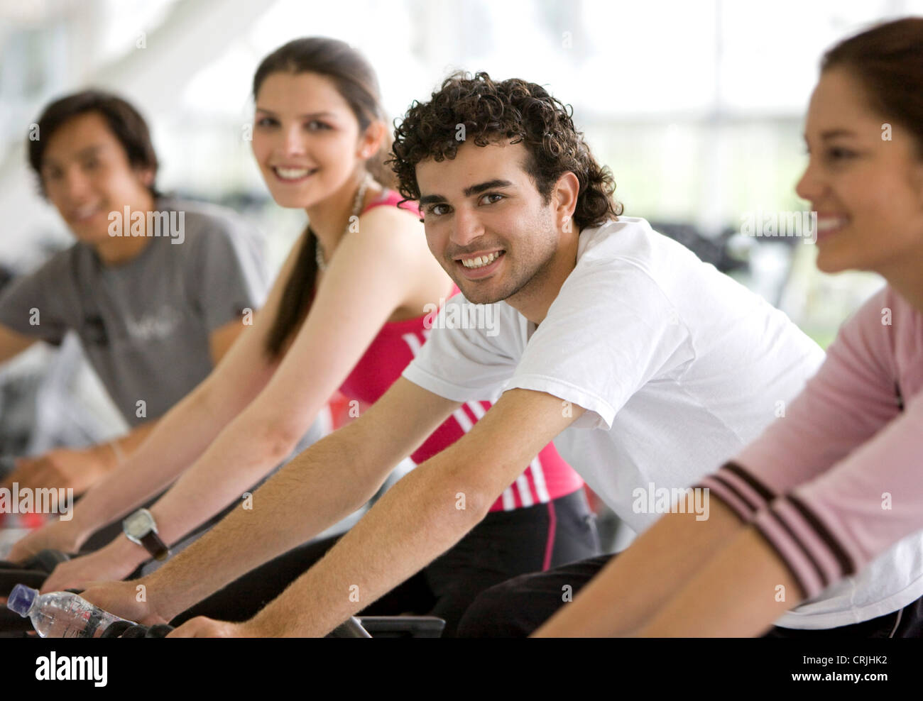 people at the gym working out on the cycling machines Stock Photo - Alamy