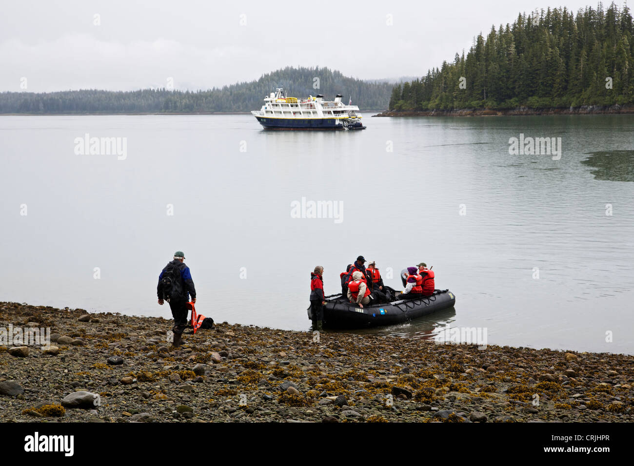 Small cruise ship and Zodiac with shore party. Near Tracy Arm southeast ...