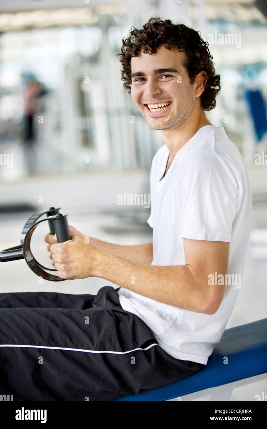 man at the gym doing exercises on a machine Stock Photo - Alamy