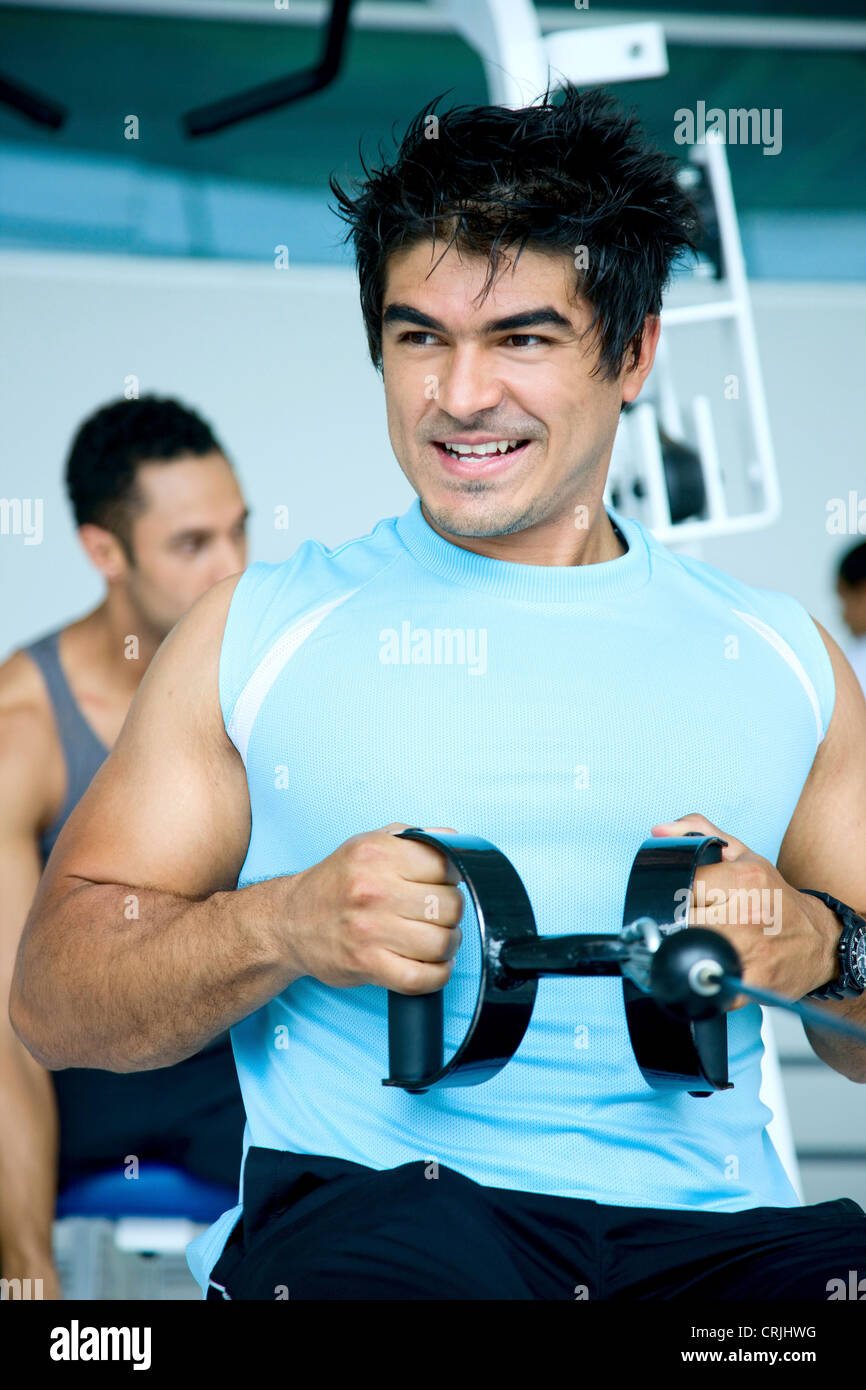man at the gym doing back machine weight training Stock Photo - Alamy