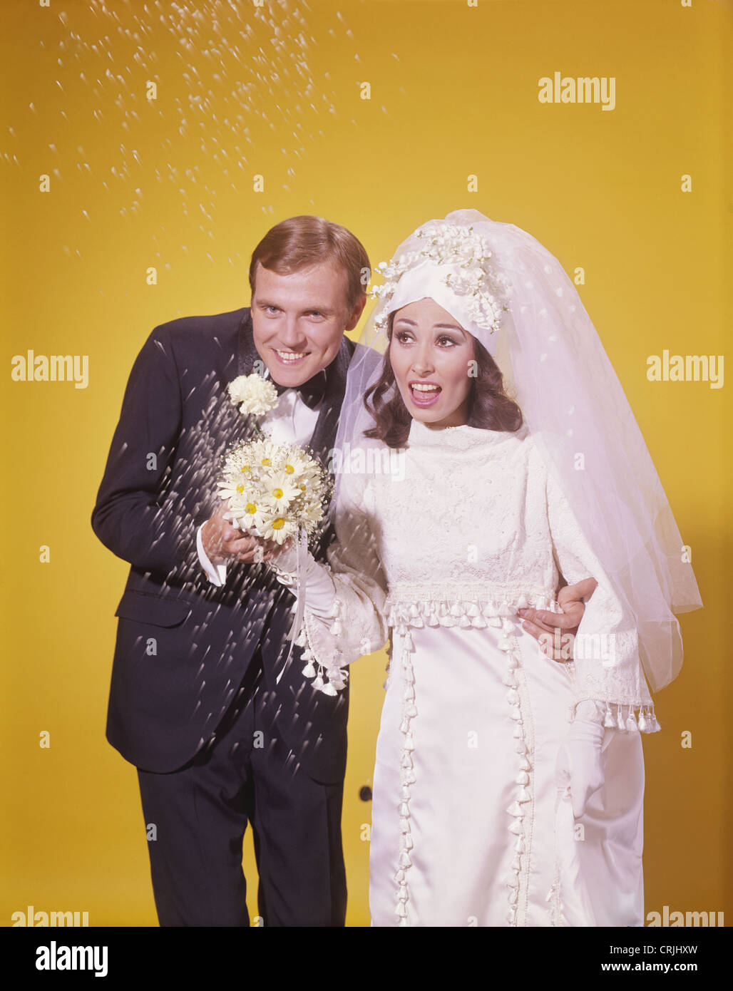 Bride and groom walking through rice for good luck Stock Photo - Alamy