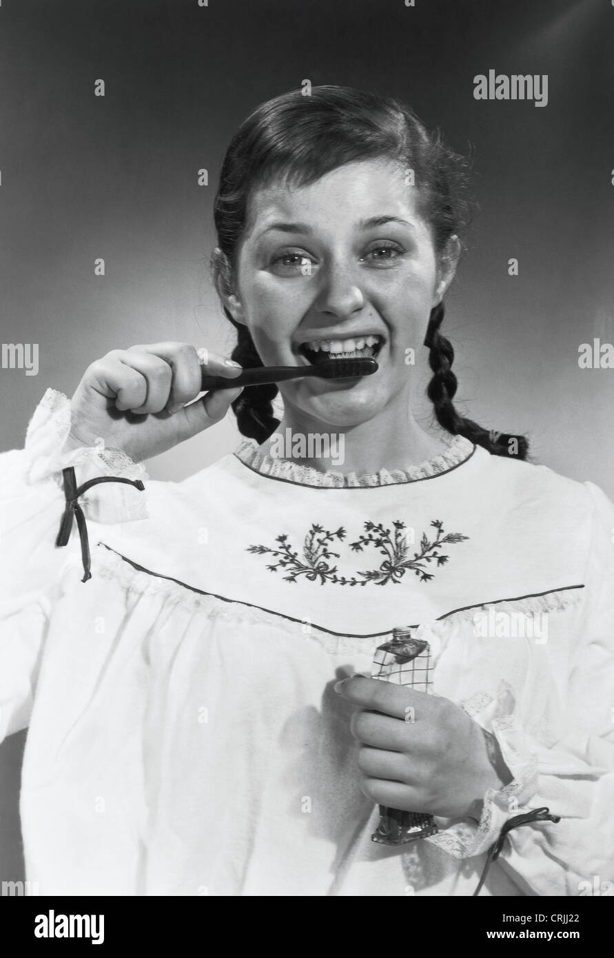Vintage portrait of a teen girl brushing her teeth Stock Photo - Alamy