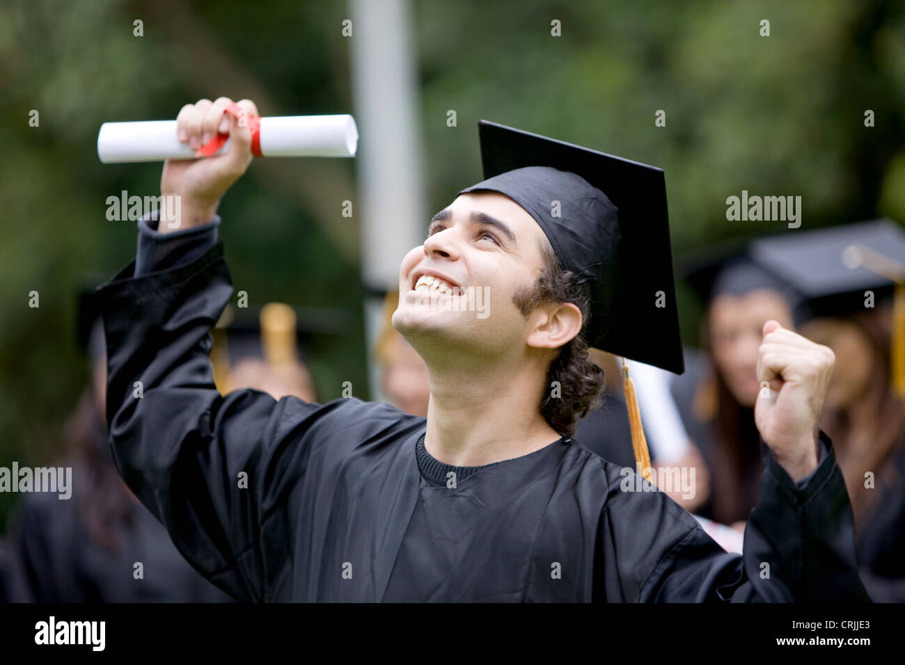 happy graduation student full of success outdoors Stock Photo - Alamy