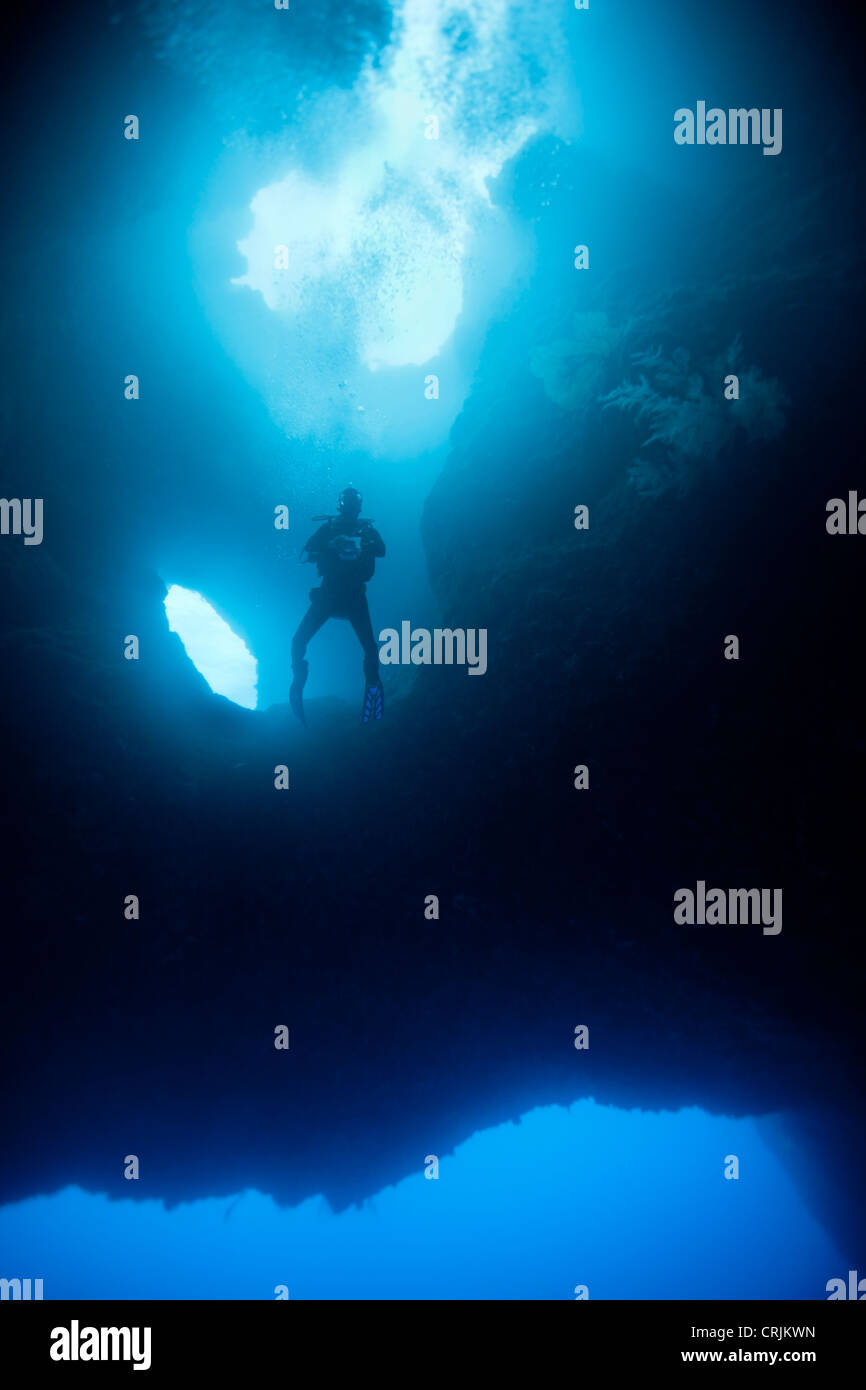 Scuba diver descending into the Blue Holes Dive Site off the islands of ...