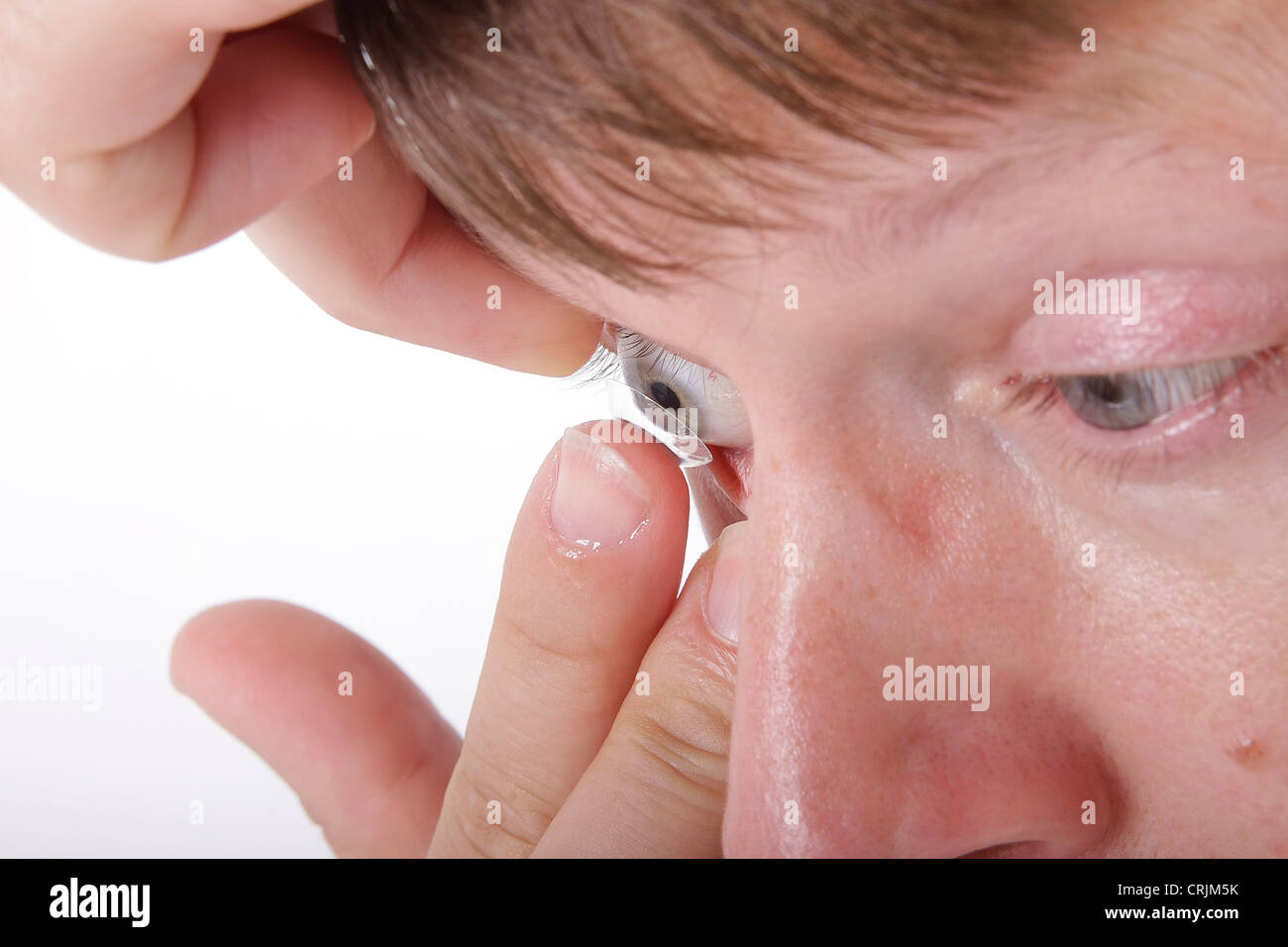 man putting in contact lenses Stock Photo - Alamy