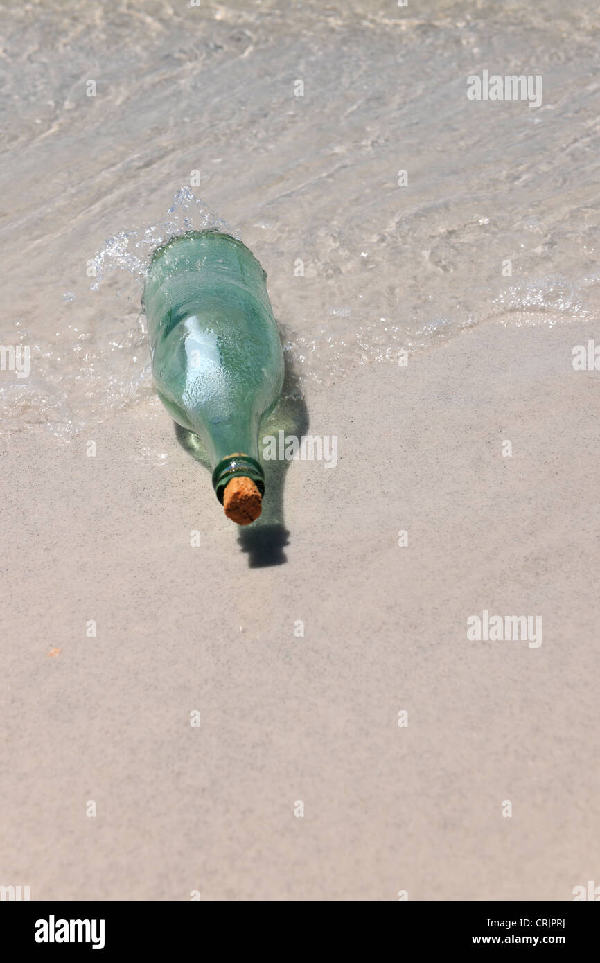 Message in a bottle on sandy shore Stock Photo - Alamy
