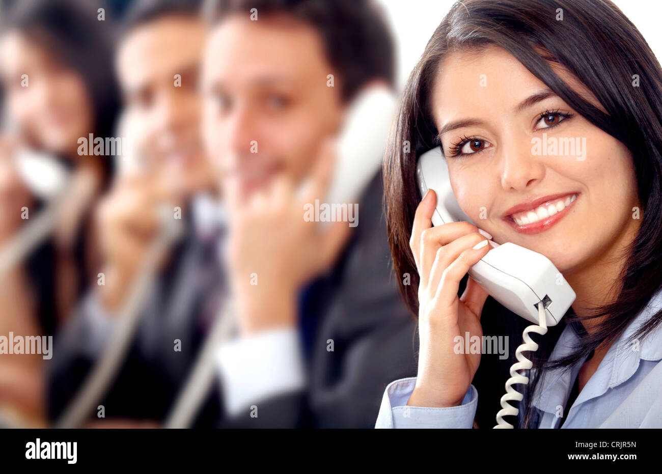 customer support team lead by a friendly girl smiling in an office ...