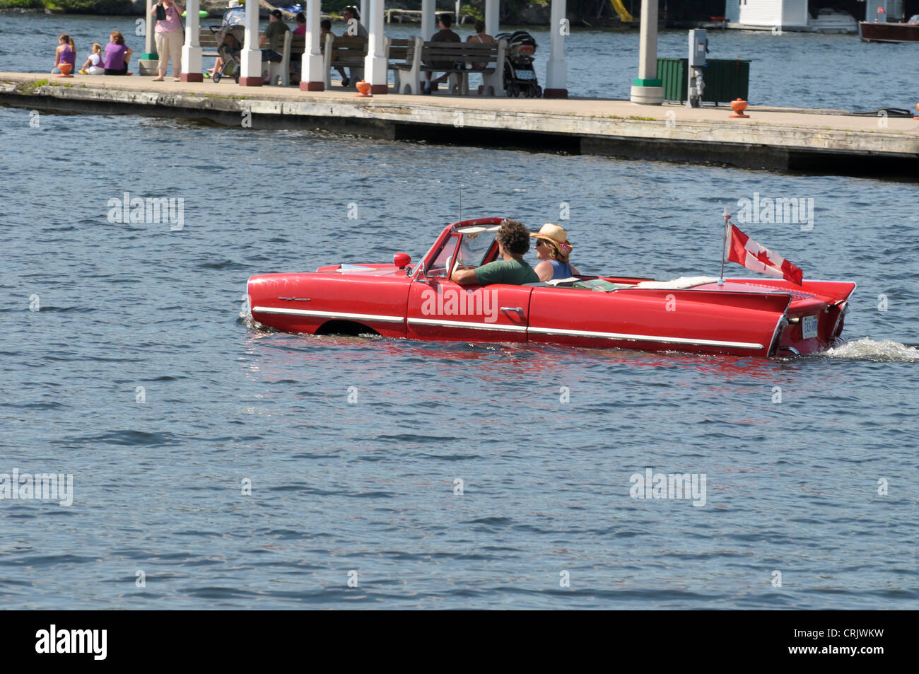 Red car converted into a boat Stock Photo - Alamy