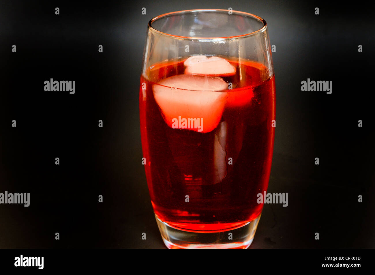 Red cocktail against black background Stock Photo - Alamy