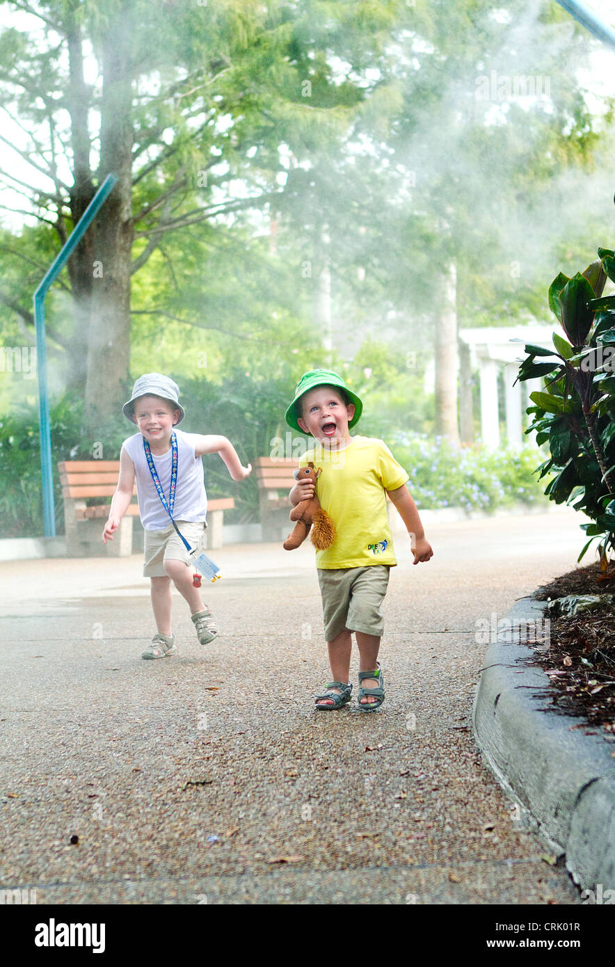 Two brothers having fun in the mist spray in sea world, Orlando Stock ...