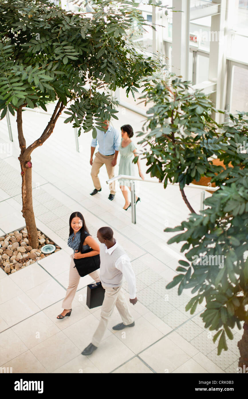 Business people walking in lobby Stock Photo - Alamy
