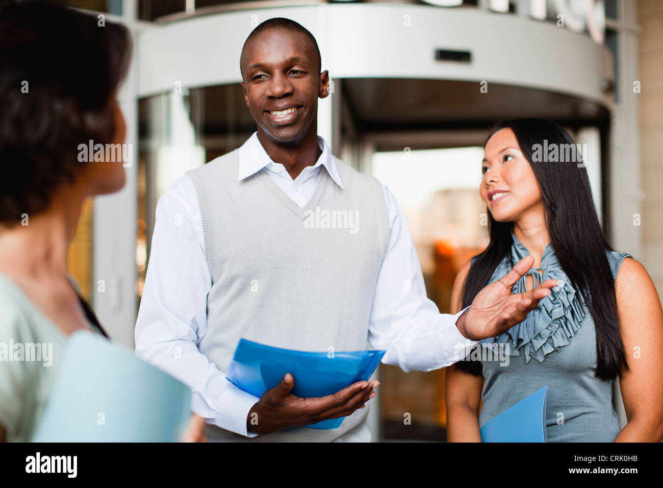 Business people talking outside building Stock Photo - Alamy
