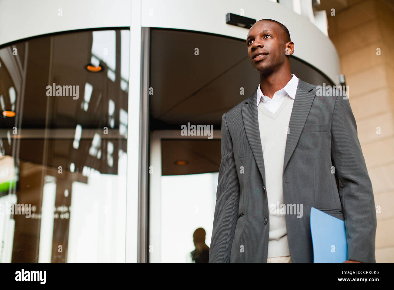 Businessman walking outside building Stock Photo - Alamy