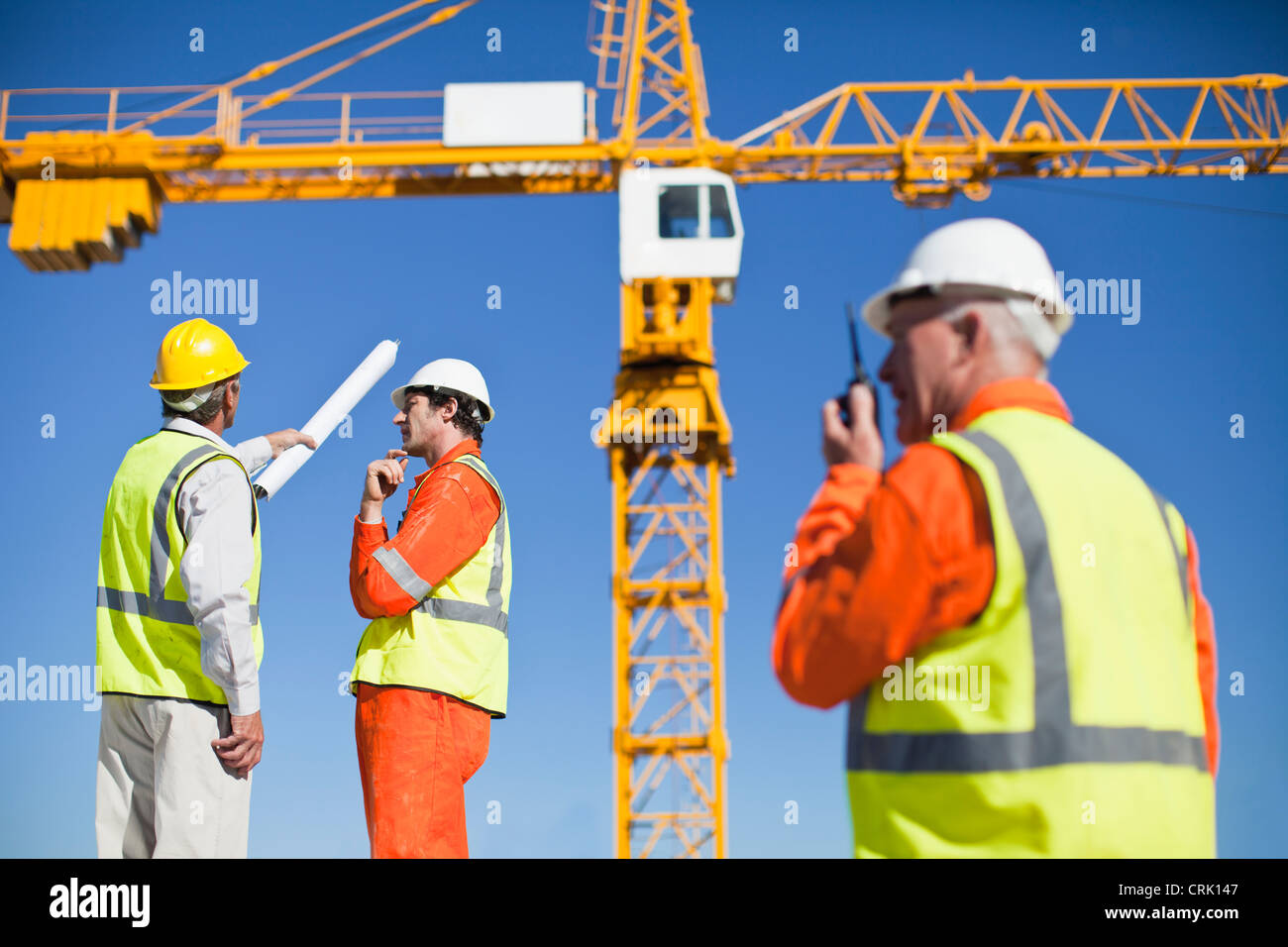 Workers talking at construction site Stock Photo - Alamy