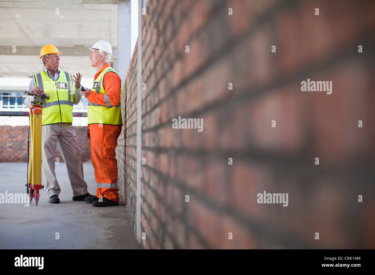 Workers talking at construction site Stock Photo - Alamy