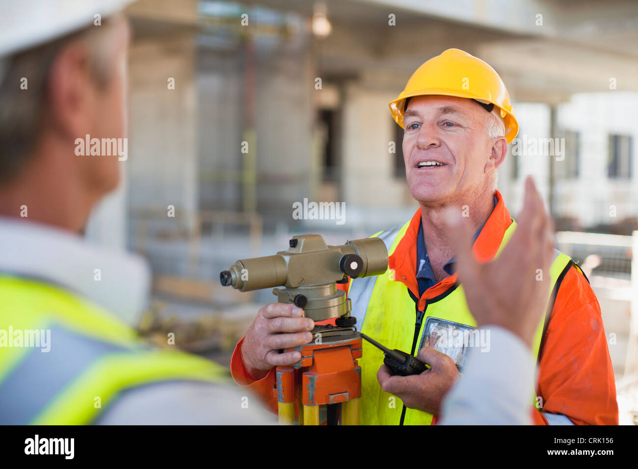Workers talking at construction site Stock Photo - Alamy