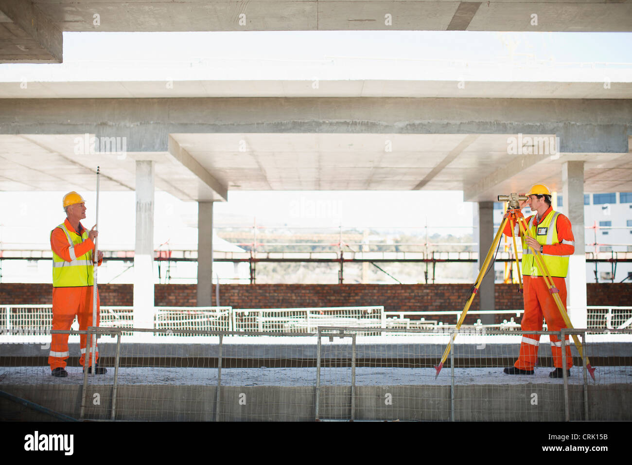 Workers using equipment on site Stock Photo - Alamy