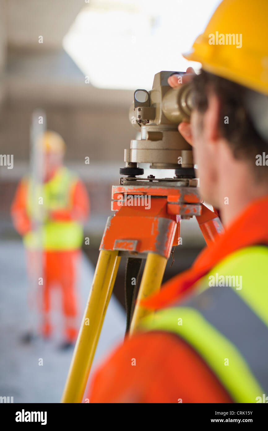 Workers using equipment on site Stock Photo - Alamy