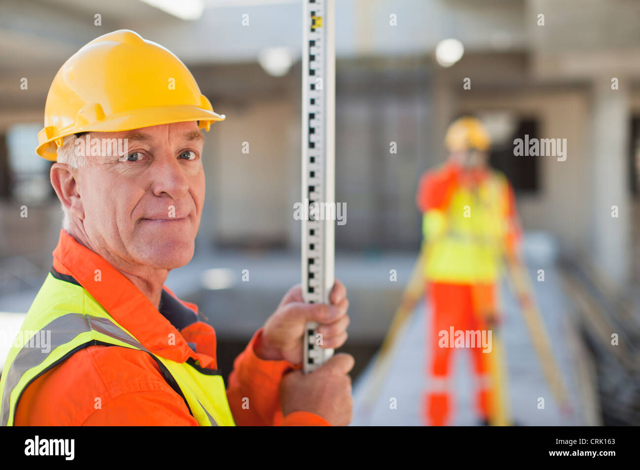 Workers using equipment on site Stock Photo - Alamy