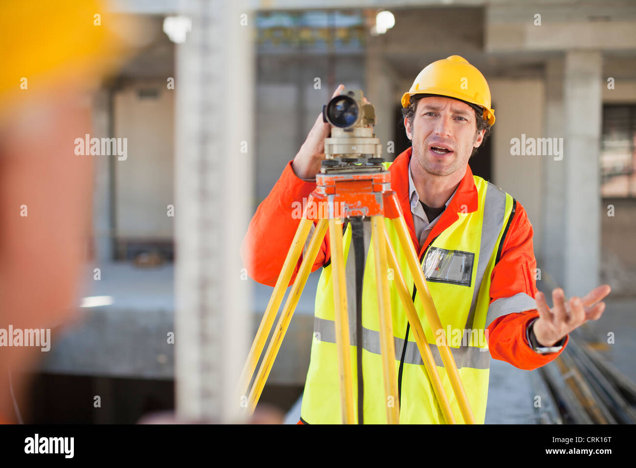 Workers using equipment on site Stock Photo - Alamy