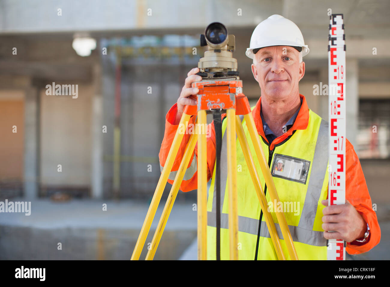 Worker using equipment on site Stock Photo - Alamy