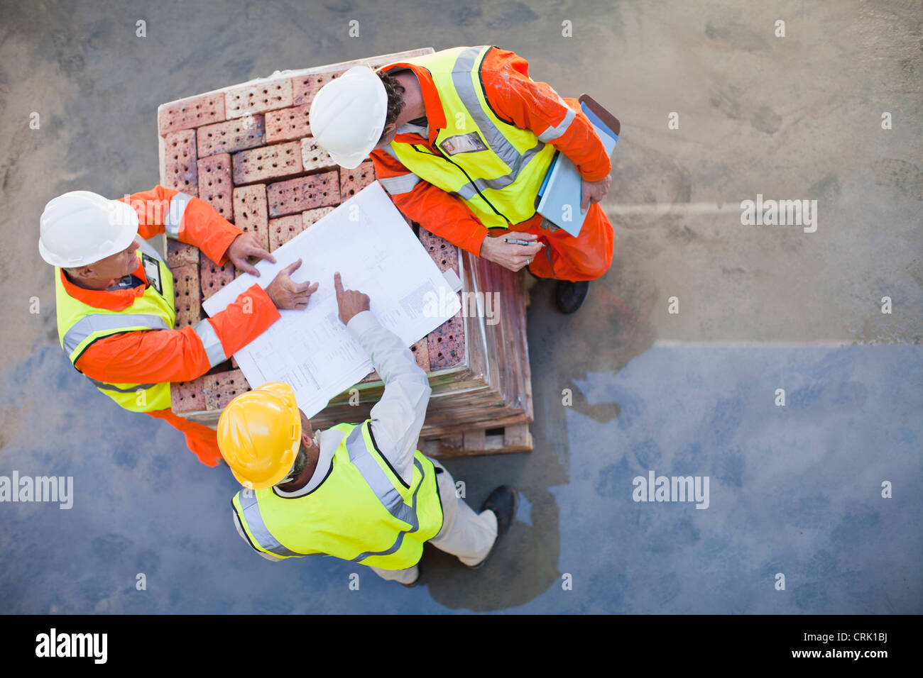 Construction workers reading blueprint on hi-res stock photography and ...