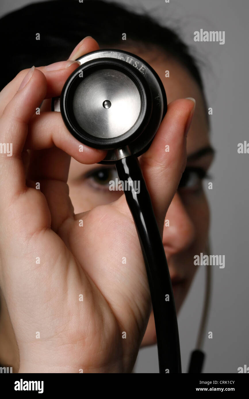 A young nurse holding a stethoscope. The stethoscope allows the nurse ...