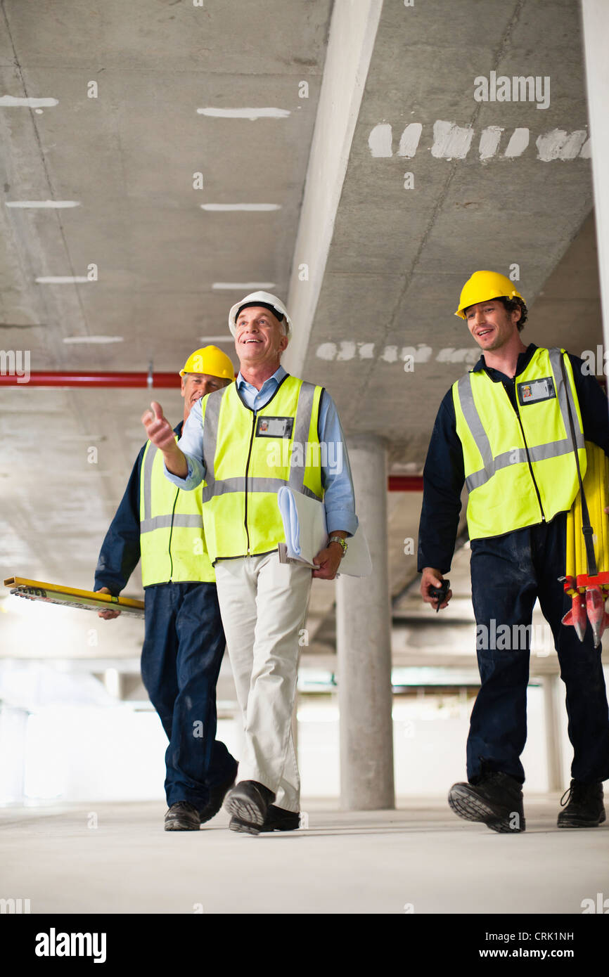 Workers walking at construction site Stock Photo - Alamy