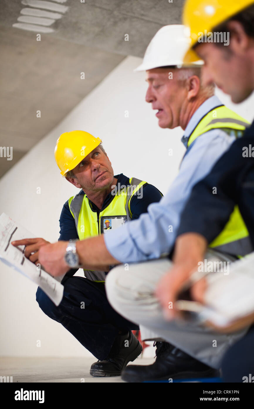 Workers talking at construction site Stock Photo - Alamy