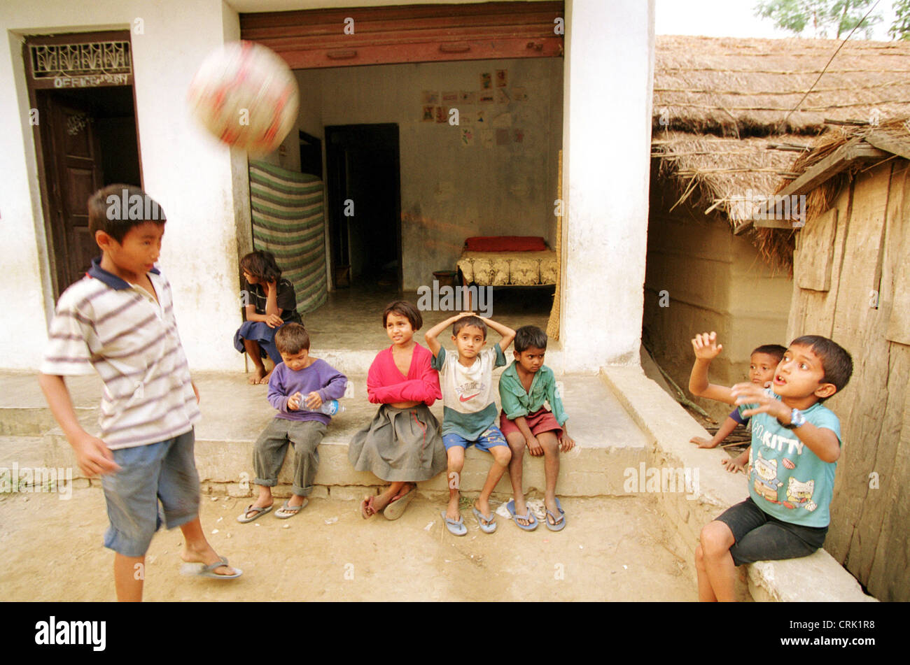 Orphans play ball before the orphanage in Nepal Stock Photo - Alamy
