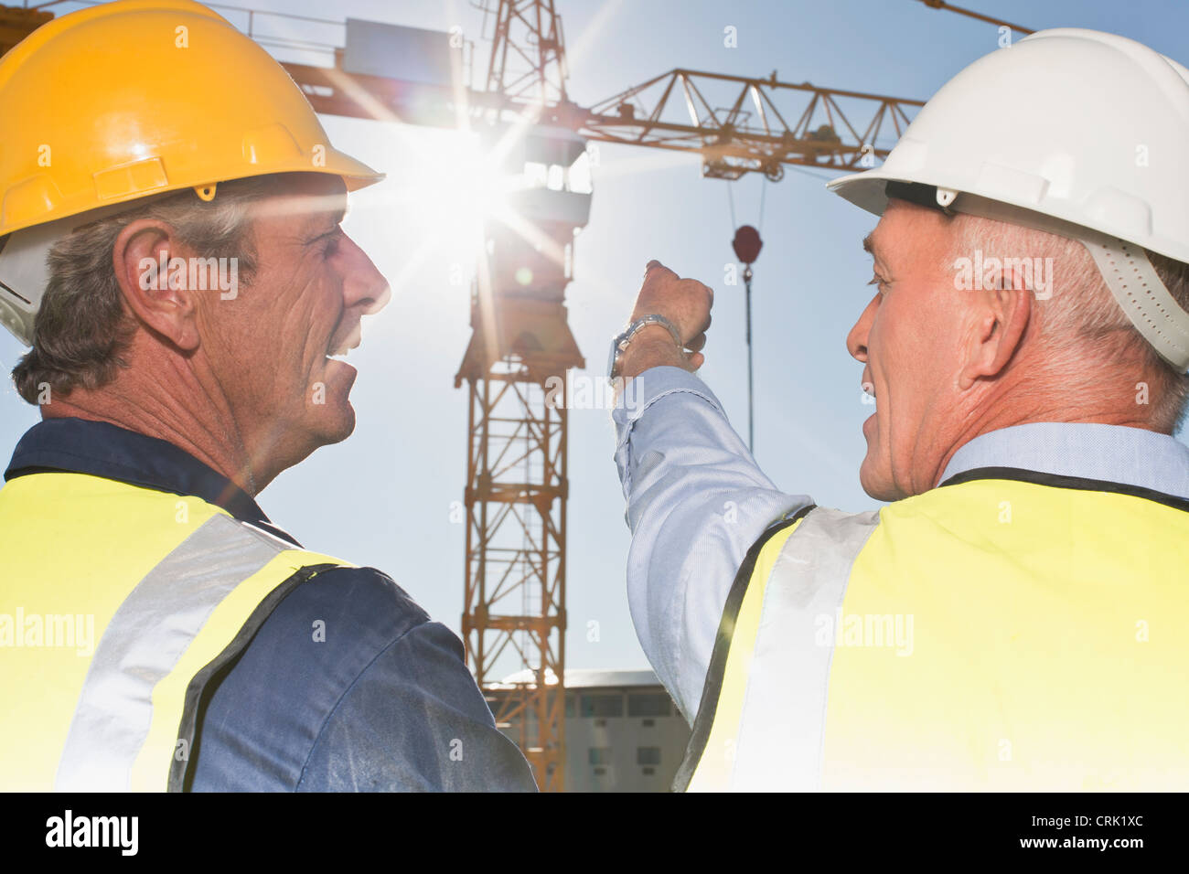 Workers talking on construction site Stock Photo - Alamy