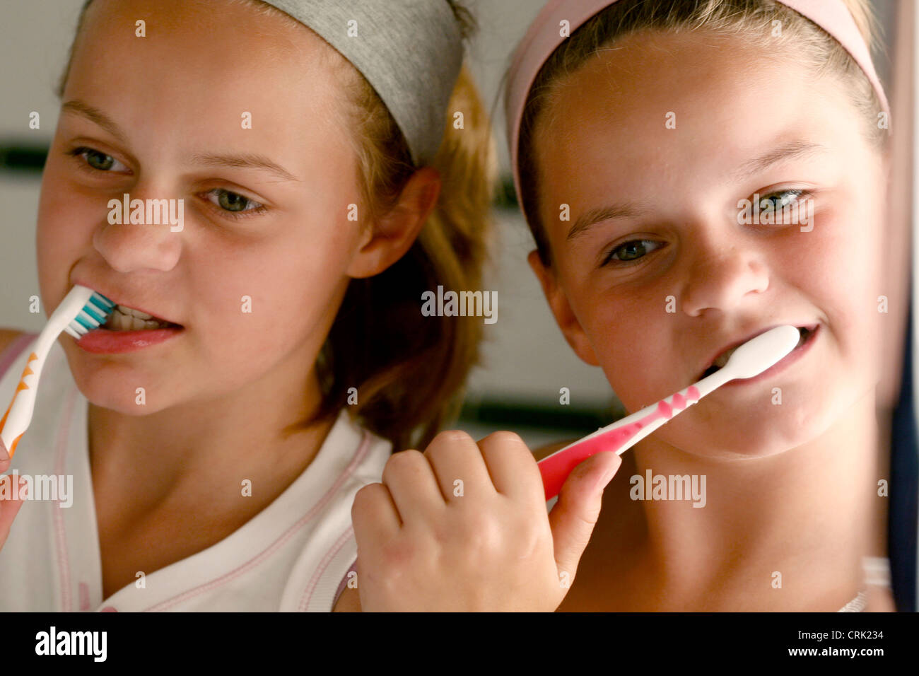 Two girls brushing their teeth Stock Photo - Alamy