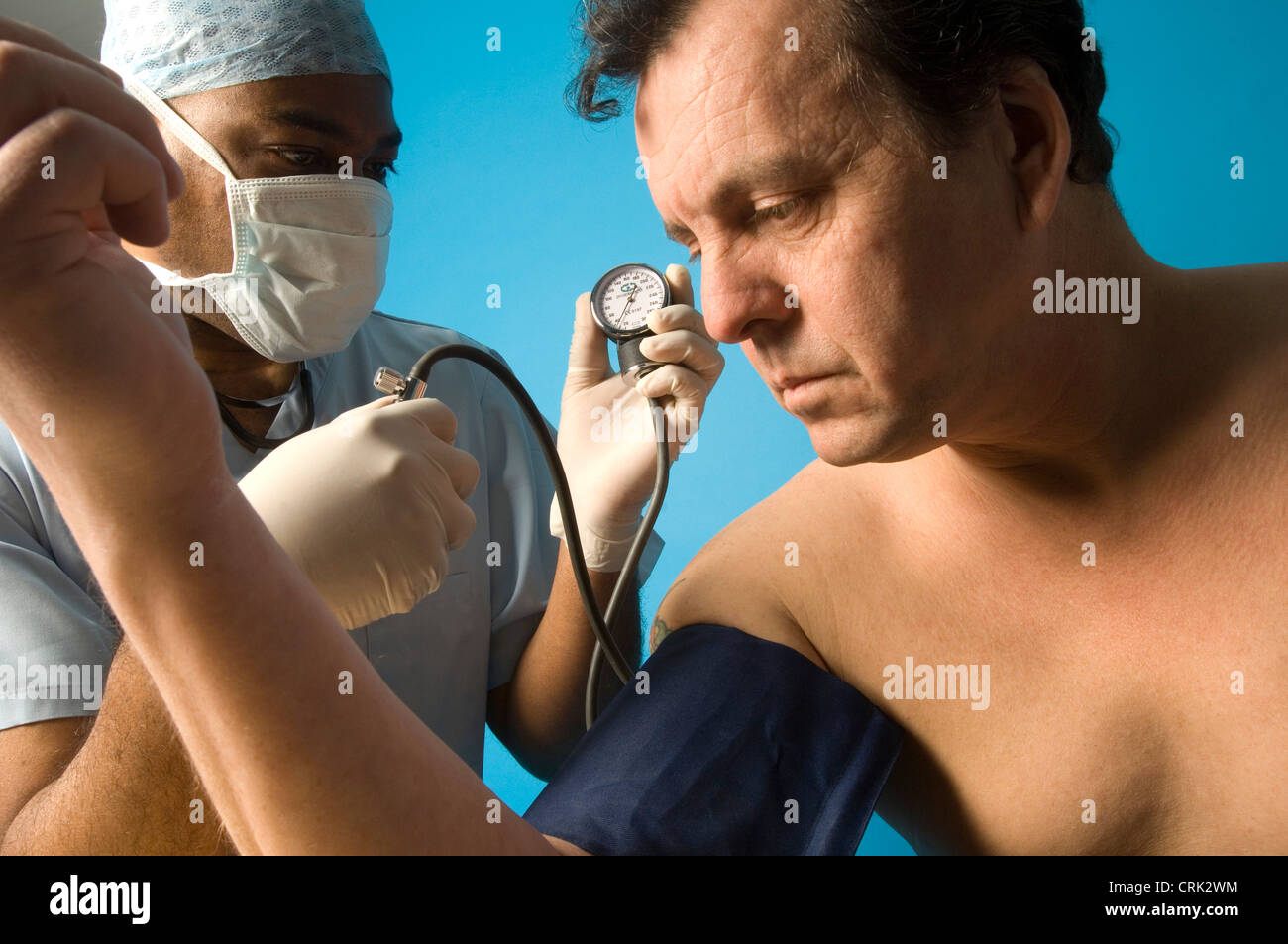 A Middle aged Man Has His Blood Pressure Measured By A Doctor Using A a-middle-aged-man-has-his-blood-pressure-measured-by-a-doctor-using-a