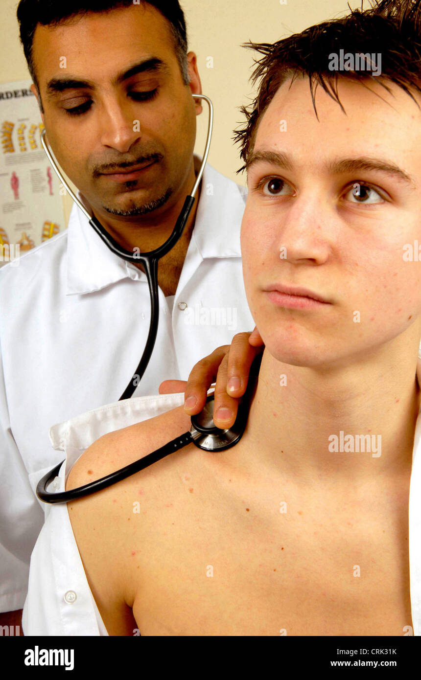 A patient having his breathing checked by a doctor using a stethoscope ...
