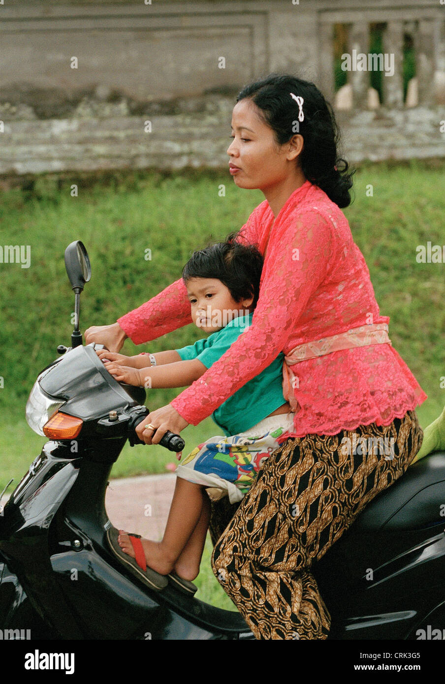 Mother with child riding a small motorcycle Stock Photo - Alamy
