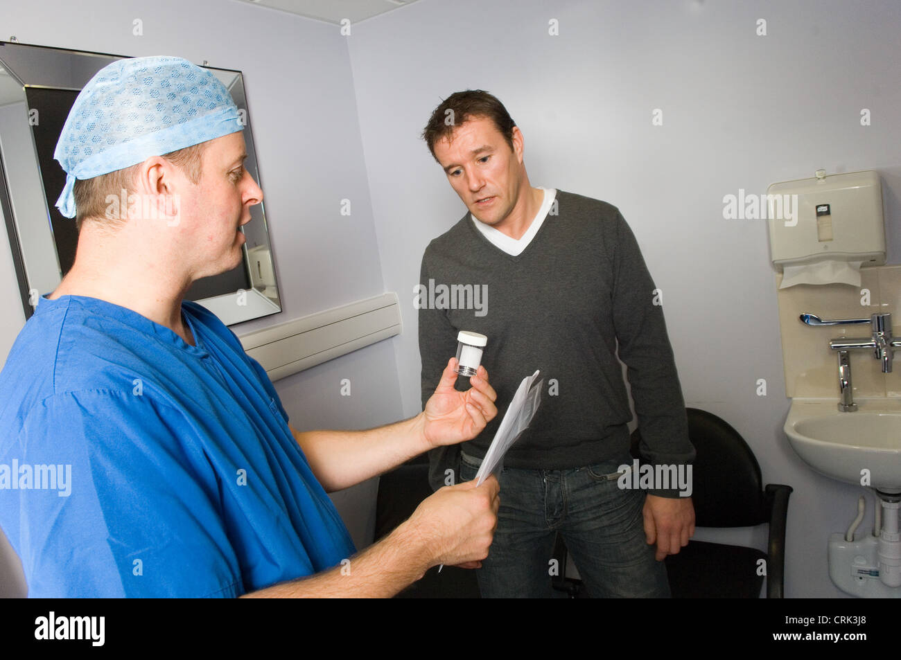 doctor talking to patient with his sample in hand Stock Photo - Alamy