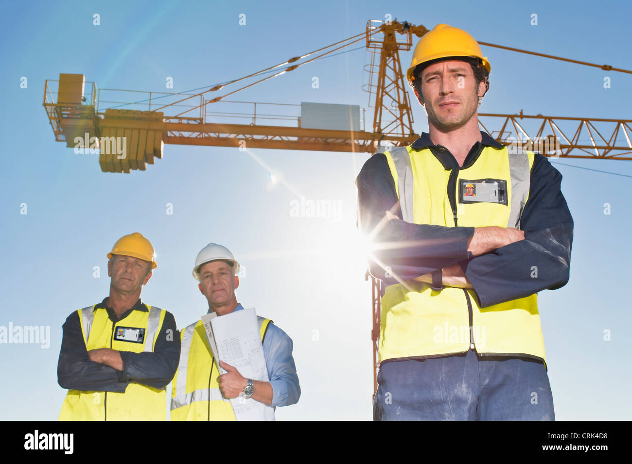 Workers standing at construction site Stock Photo - Alamy