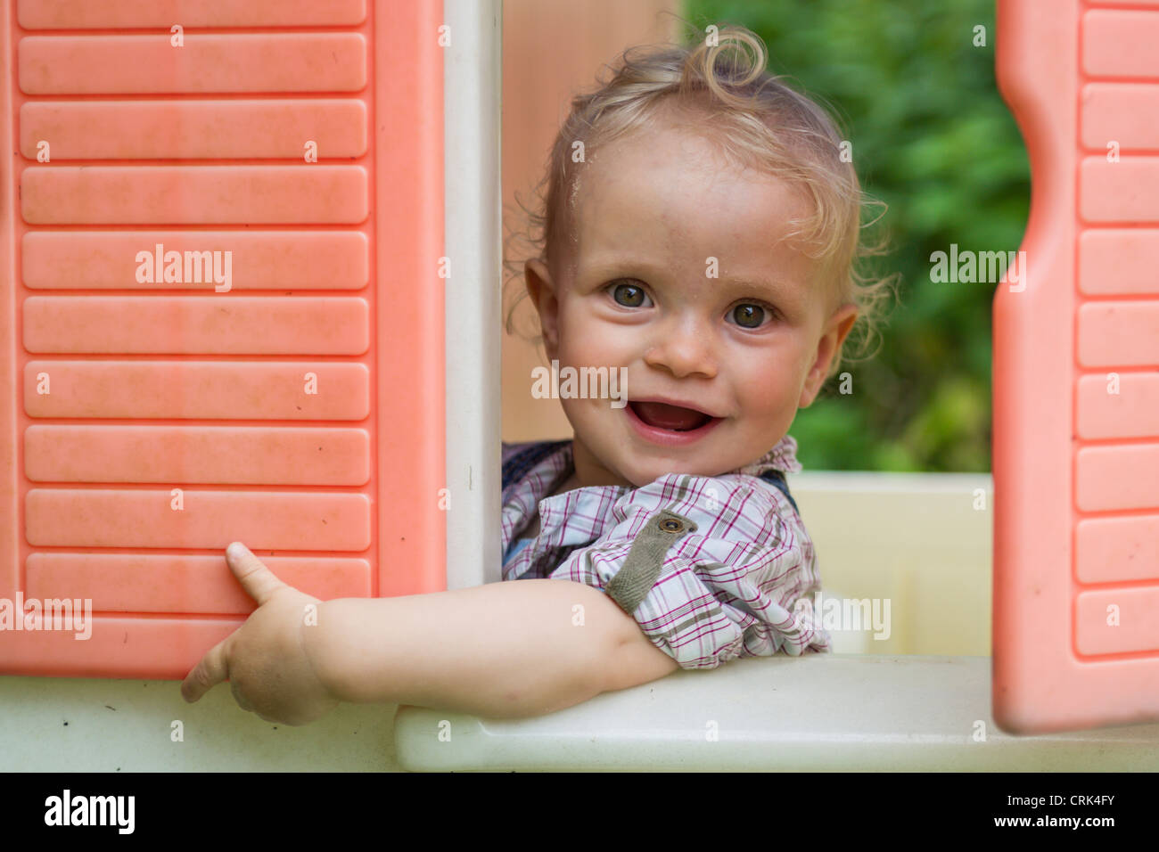 Baby girl smiling in playhouse Stock Photo - Alamy