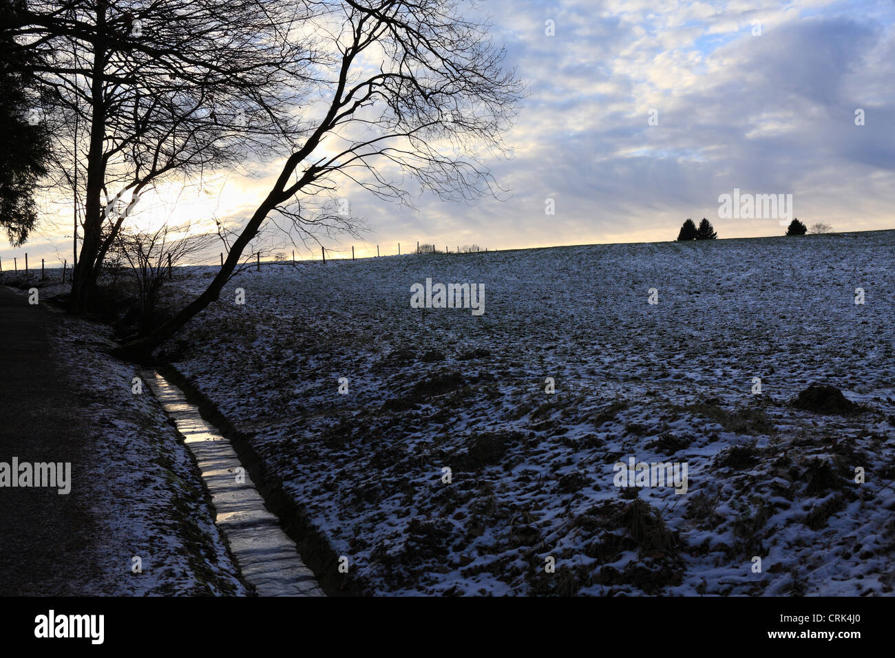Frozen water stream in farm landscape, Chiemgau Upper Bavaria Germany ...