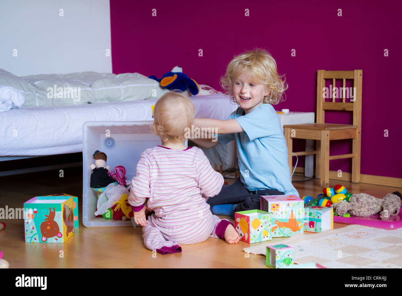 Siblings playing together in bedroom Stock Photo - Alamy