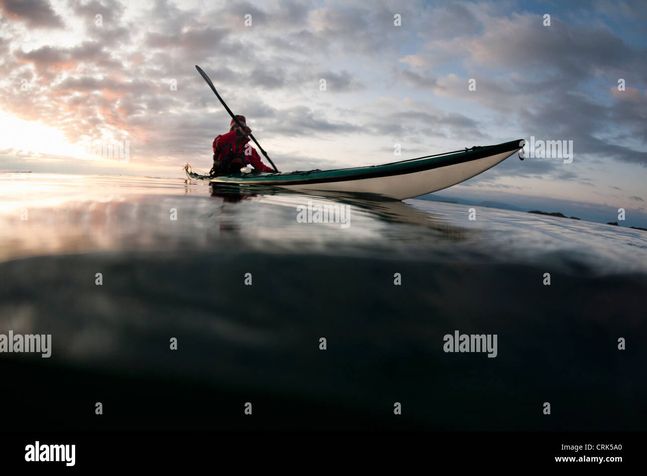Man kayaking on still lake Stock Photo - Alamy